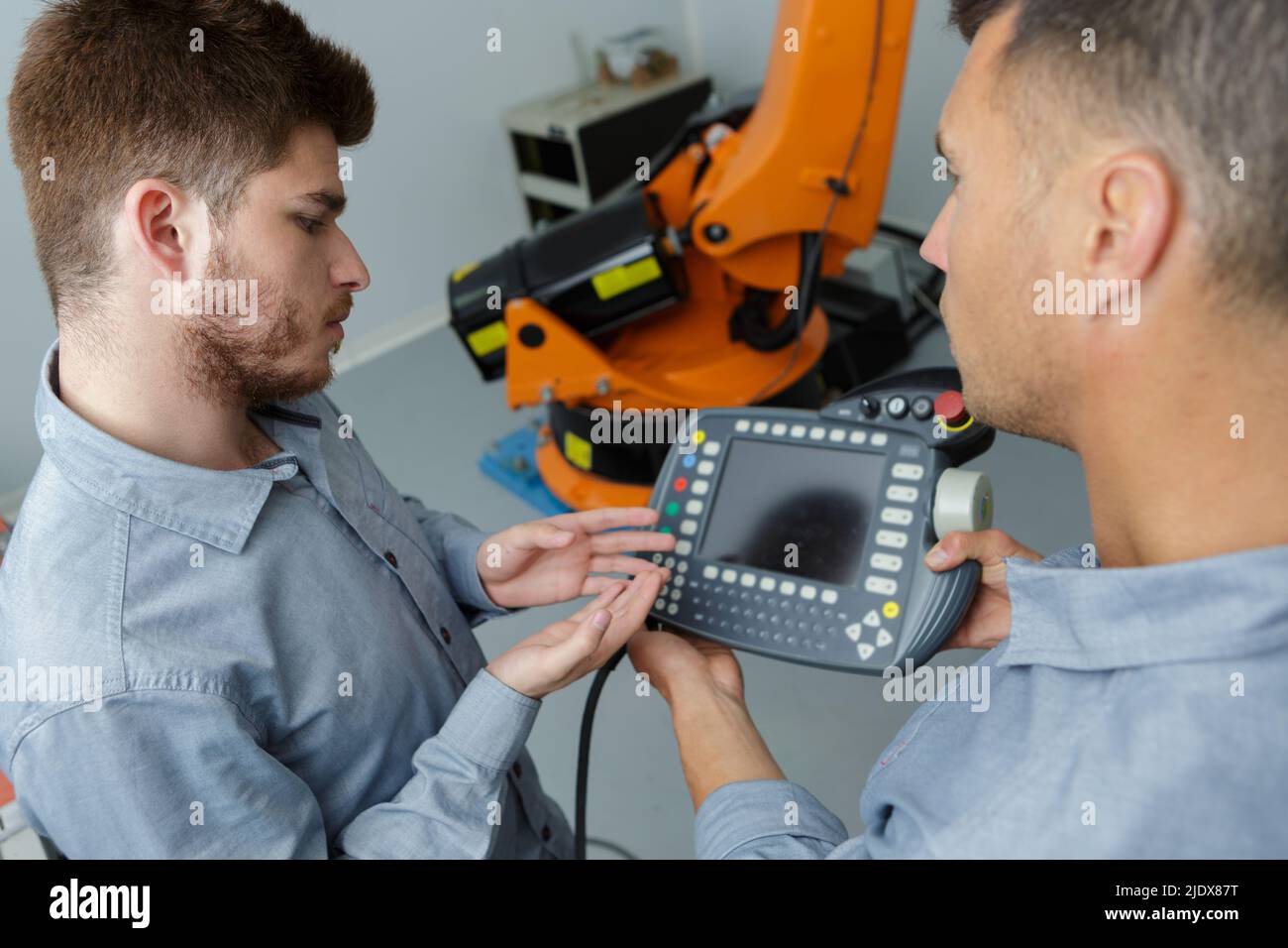 teacher and student building a robotic arm Stock Photo - Alamy