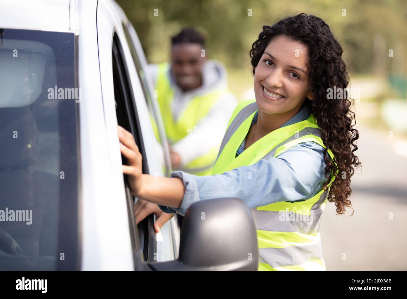 happy friends pushing broken car Stock Photo - Alamy