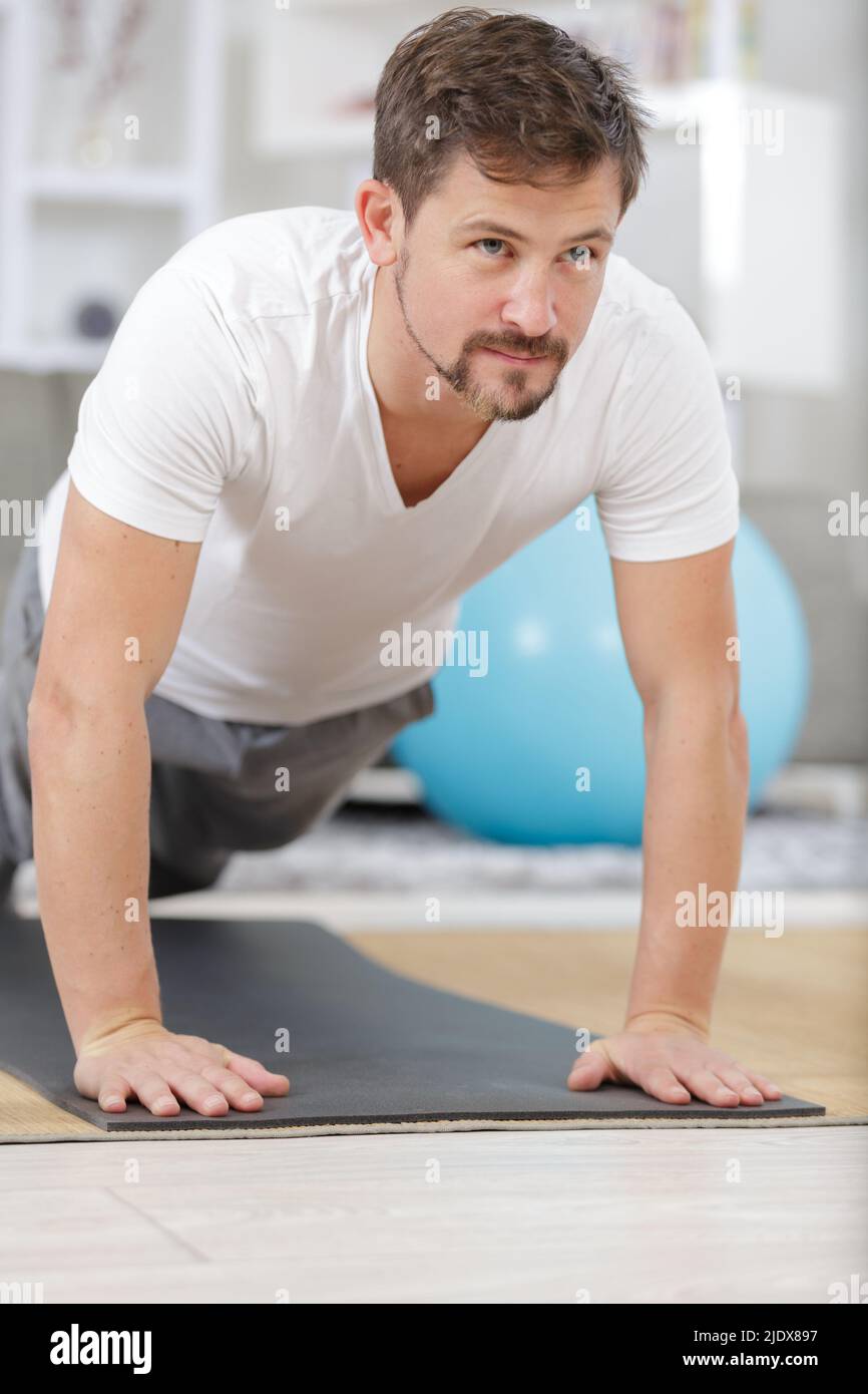 confident muscled young man wearing sport wear exercising in gym Stock ...