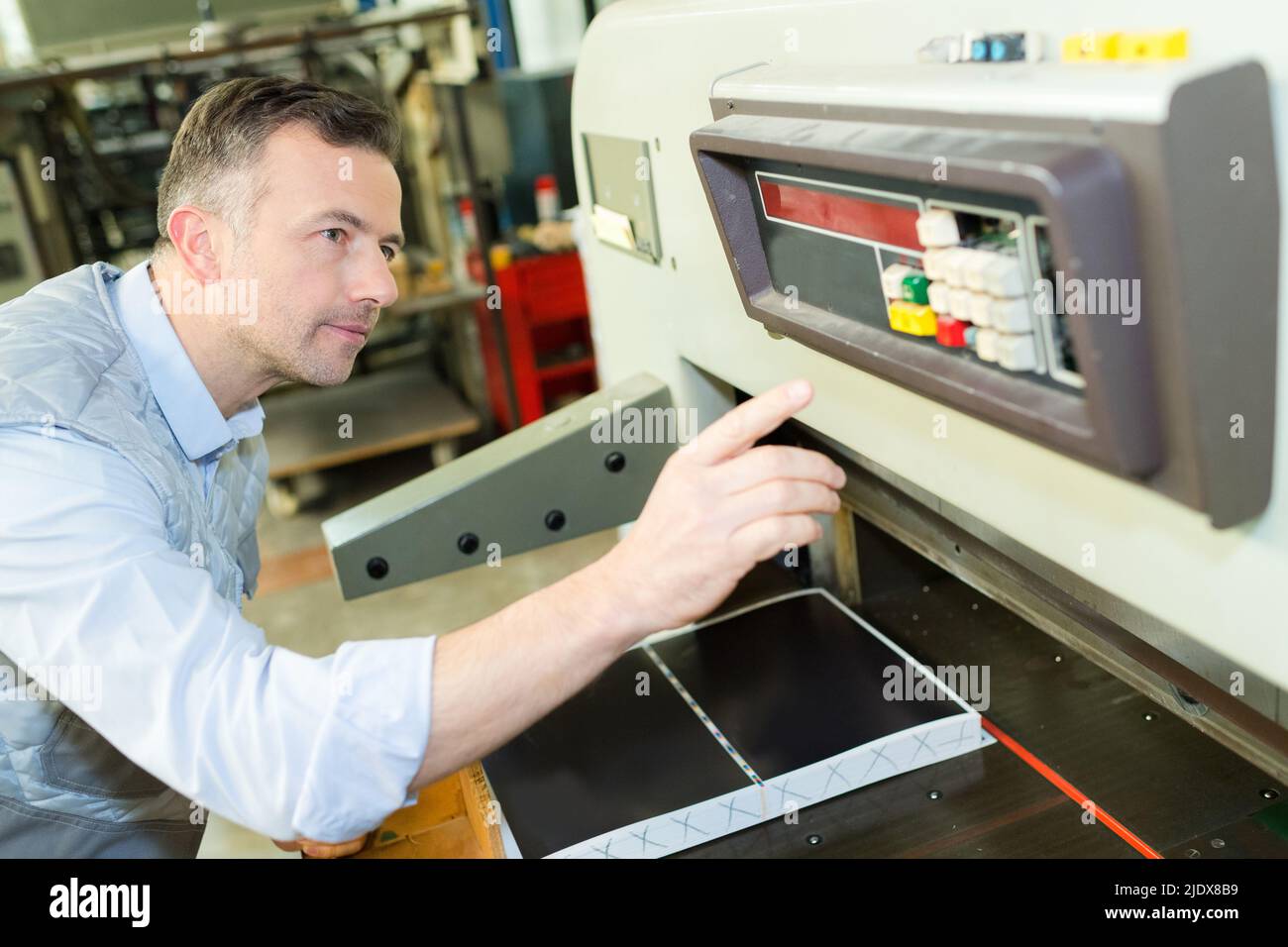 machine operator in production plant checking data Stock Photo - Alamy