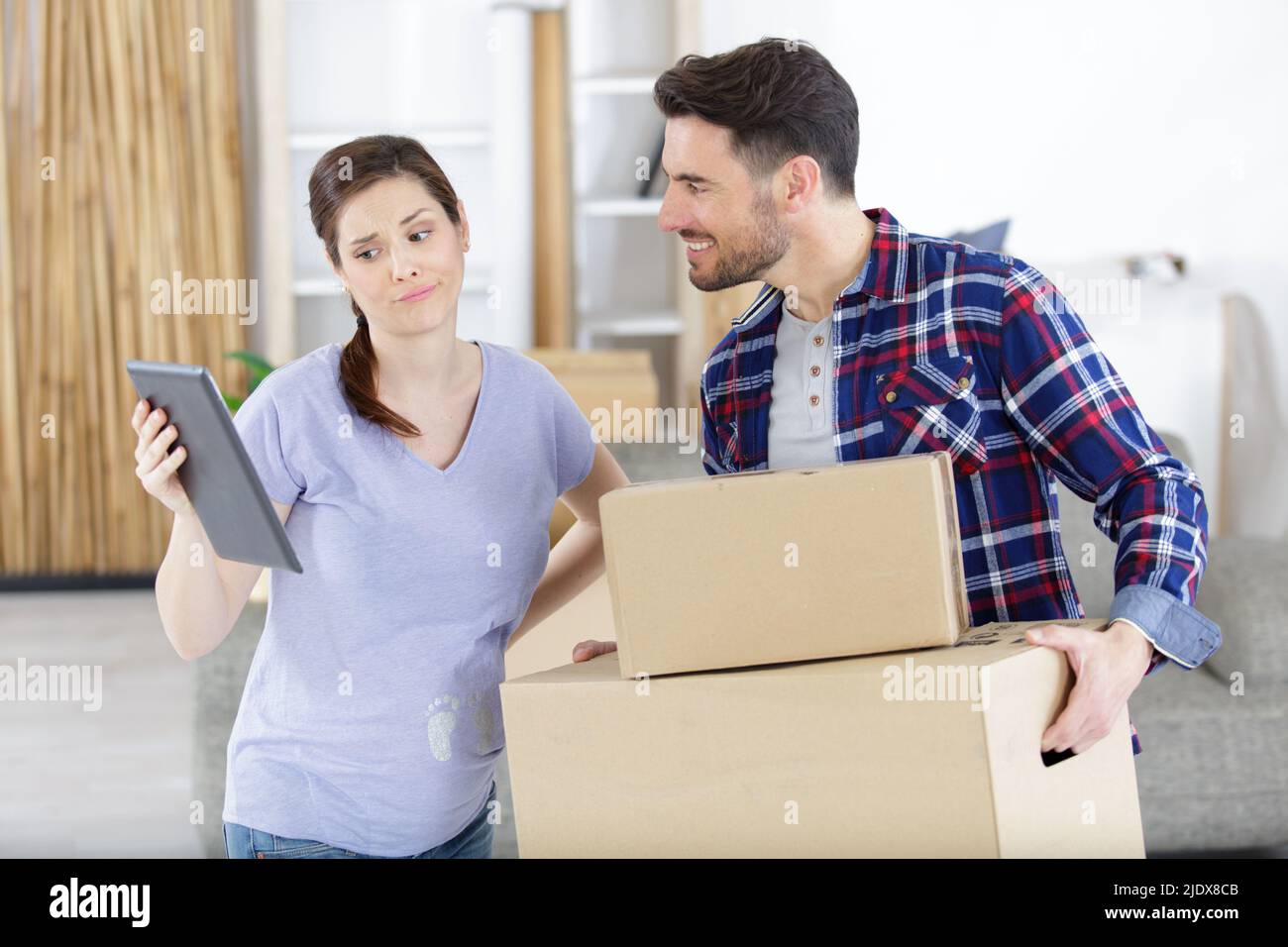 pregnant woman shows tablet to man Stock Photo - Alamy