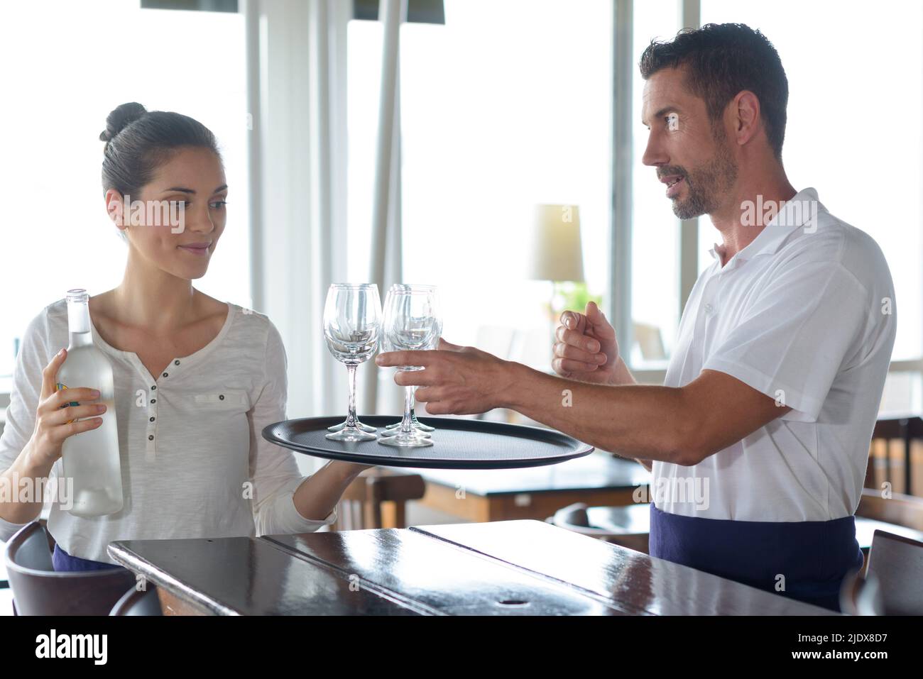 waiter and waitress holding a serving tray Stock Photo - Alamy