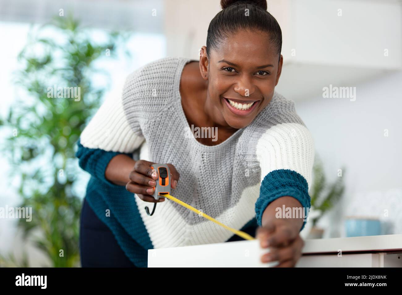 woman working on a new kitchen installation Stock Photo - Alamy