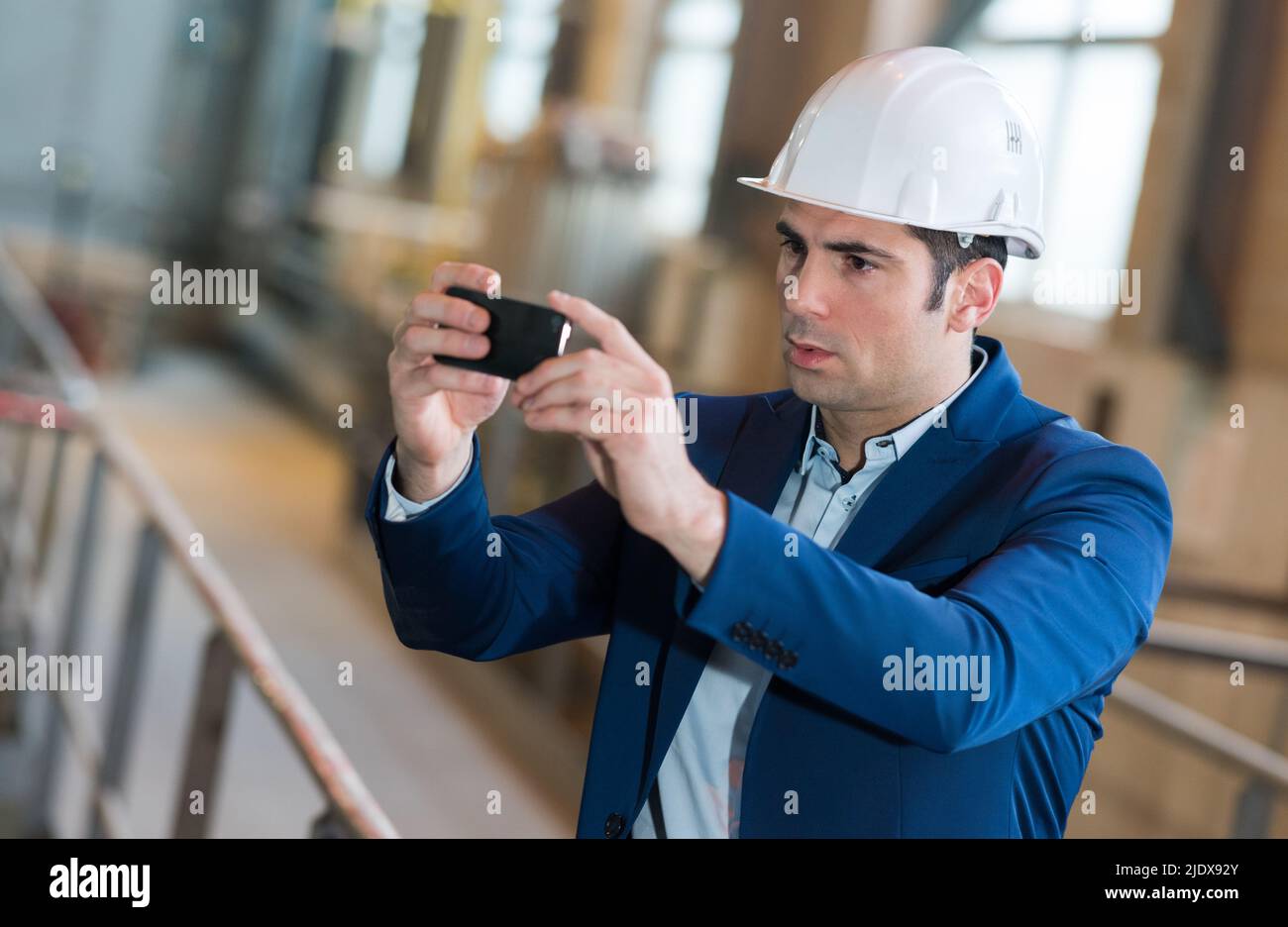 construction supervisor making phone photos Stock Photo - Alamy