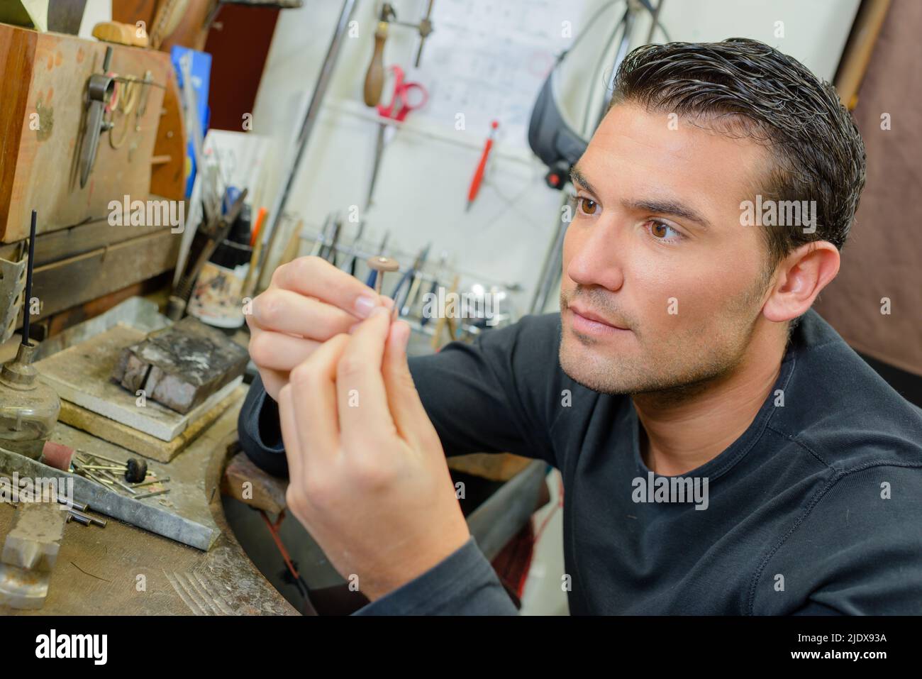 Serious young craftsman holding hi-res stock photography and images - Alamy