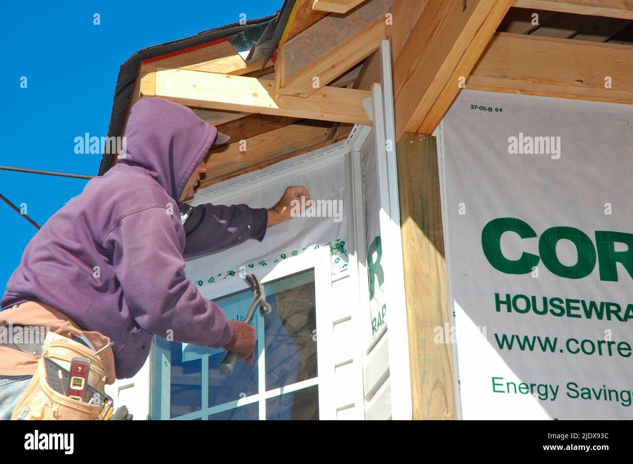 crew Installing Vinyl Siding on outside of a new home construction in ...