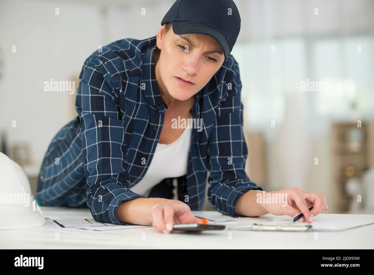 Woman checking house plan hi-res stock photography and images - Alamy