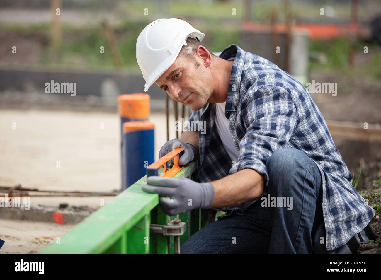 the installation wizard measures the foundation level Stock Photo - Alamy