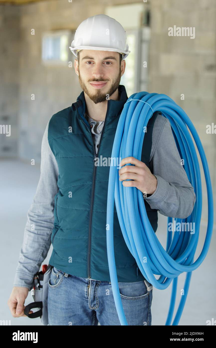 busy engineer holding pipes Stock Photo - Alamy