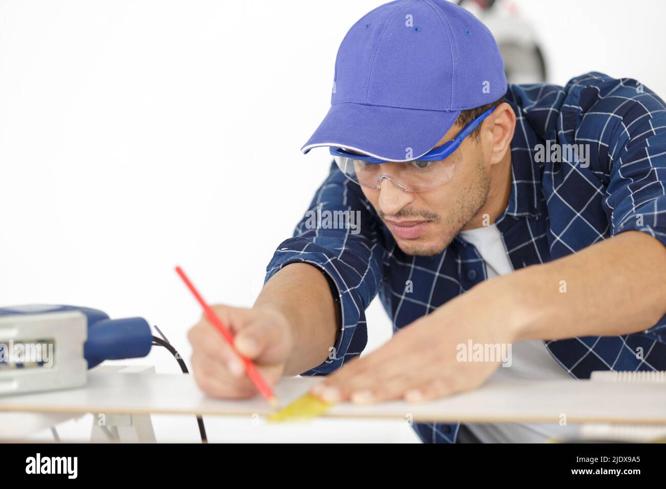 carpenter using pencil and measurement tape on wood Stock Photo - Alamy