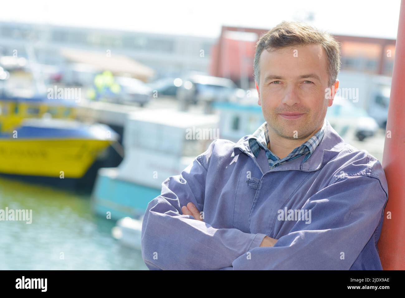 a docker posing at a port Stock Photo - Alamy