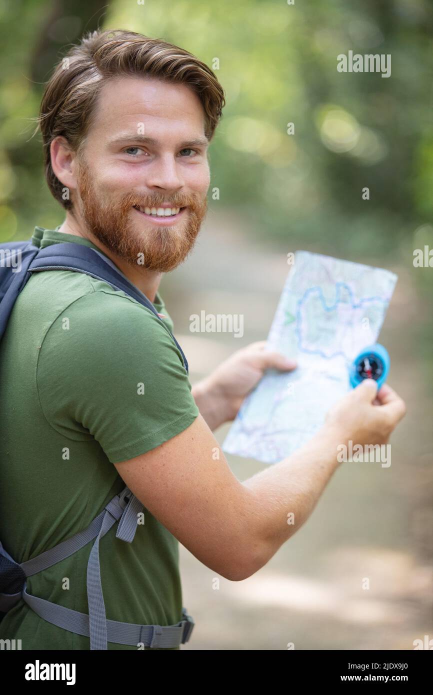 a lost hiker looking at the map Stock Photo - Alamy