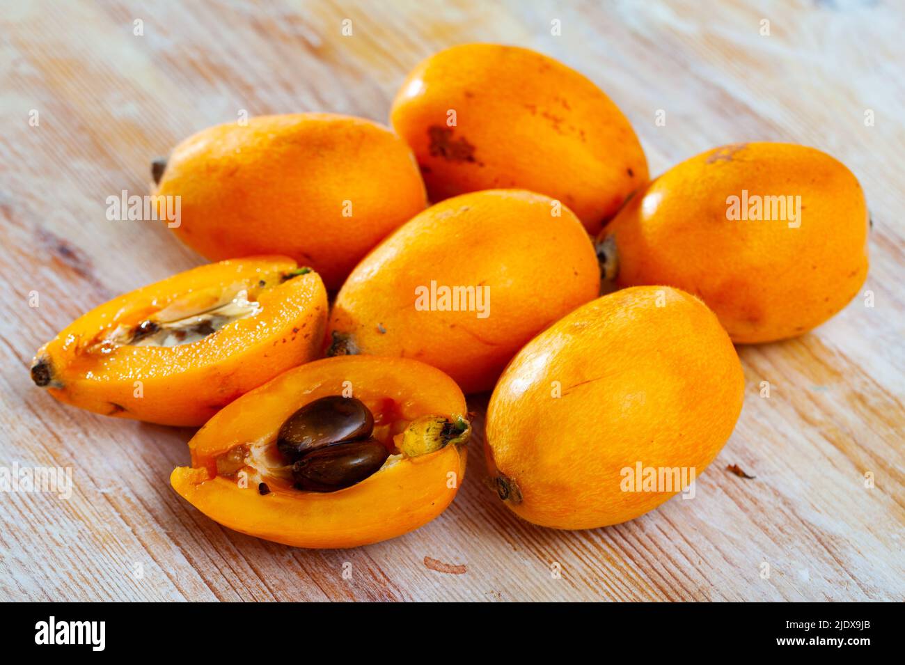 Whole and halved loquat fruits Stock Photo - Alamy
