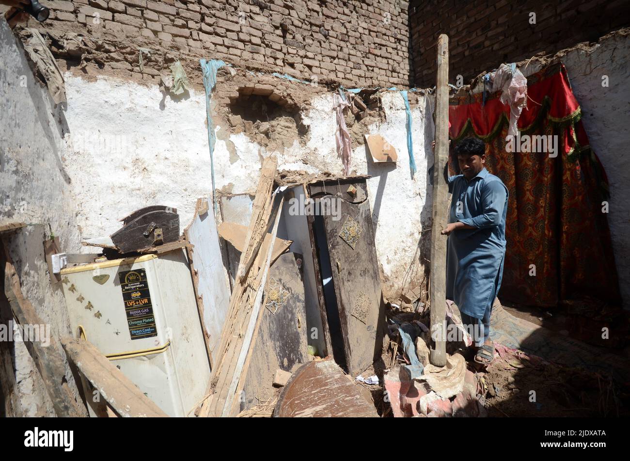 Peshawar, Pakistan. 22nd June, 2022. People inspect the damaged room ...