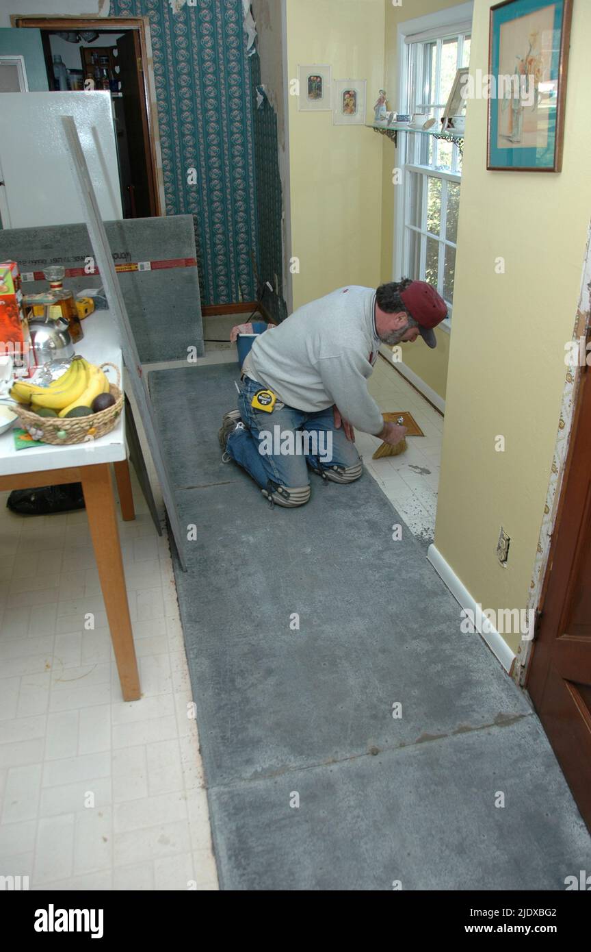 Do it yourself home owner Putting down underflooring and mastic and ...