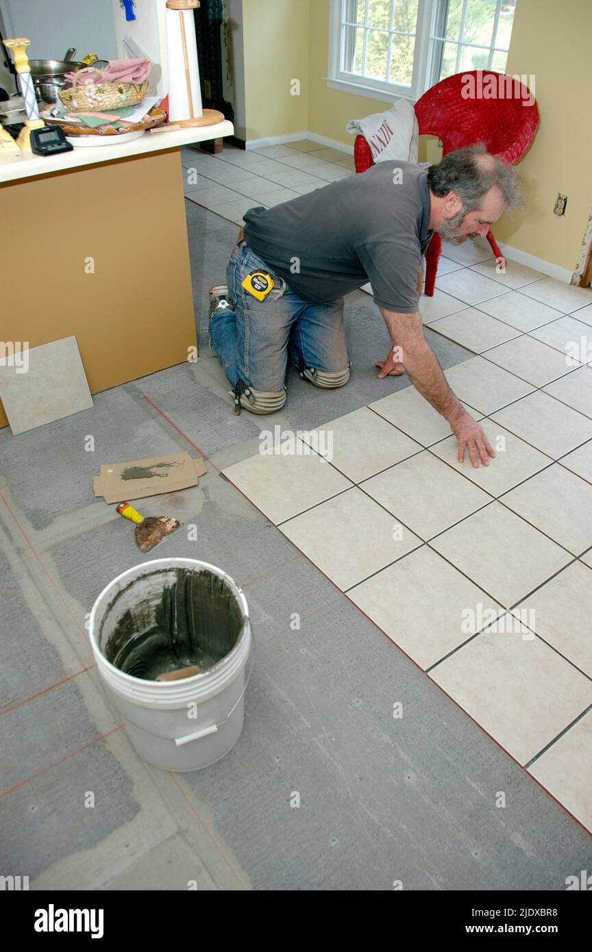 Do it yourself home owner Putting down underflooring and mastic and ...