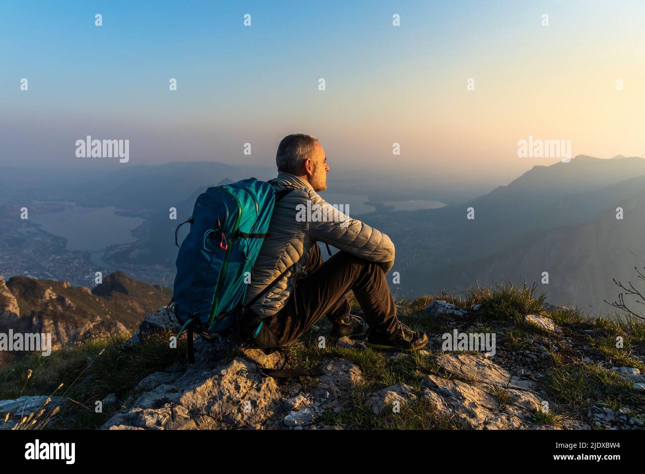 Hiker sitting on viewpoint, Orobie Alps, Lecco, Italy Stock Photo - Alamy