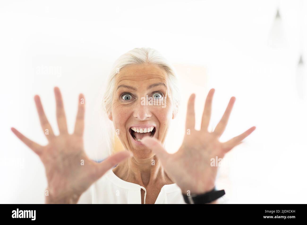 Excited woman showing palm of hands Stock Photo - Alamy