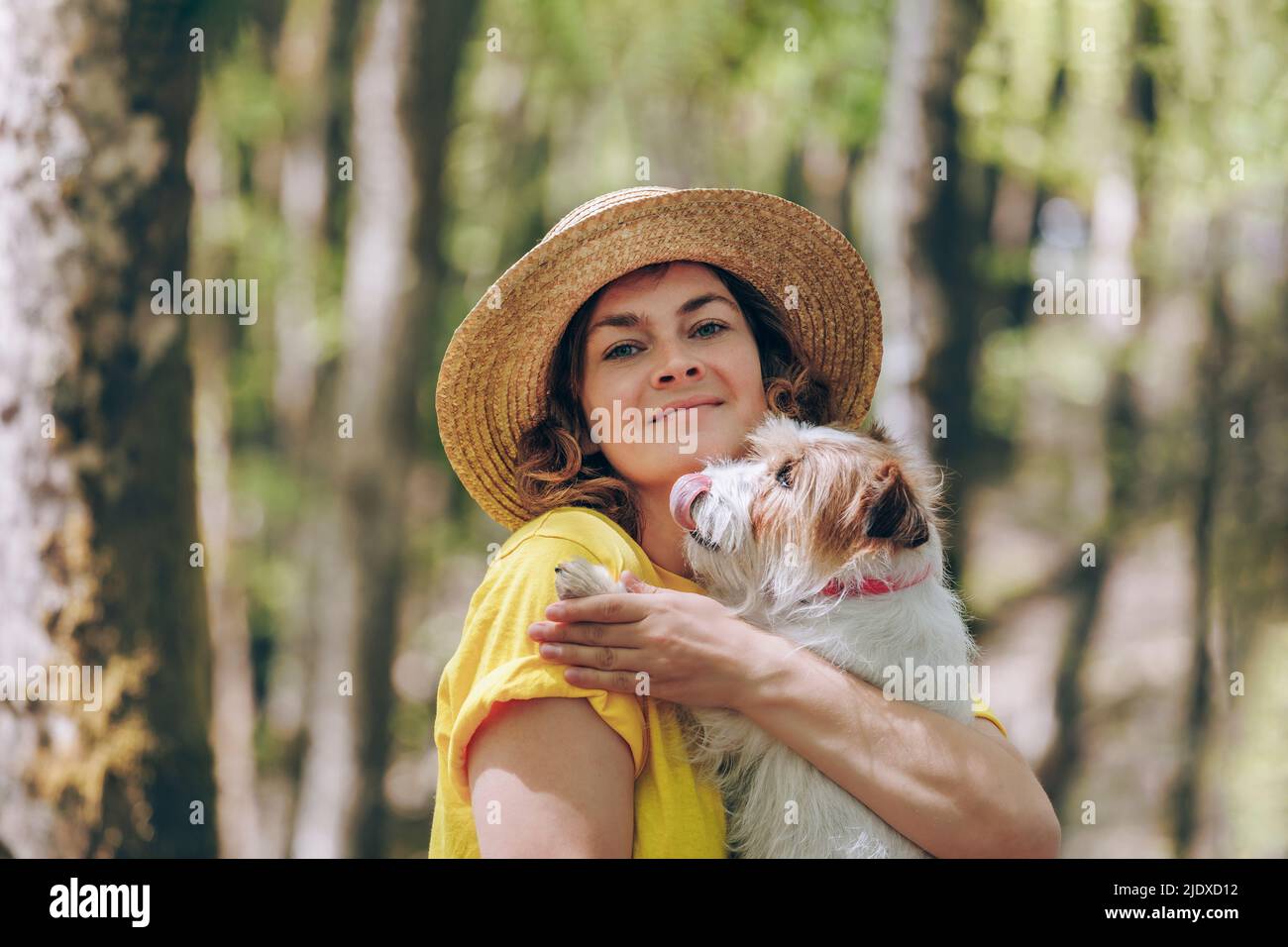 Person carrying dog hi-res stock photography and images - Alamy