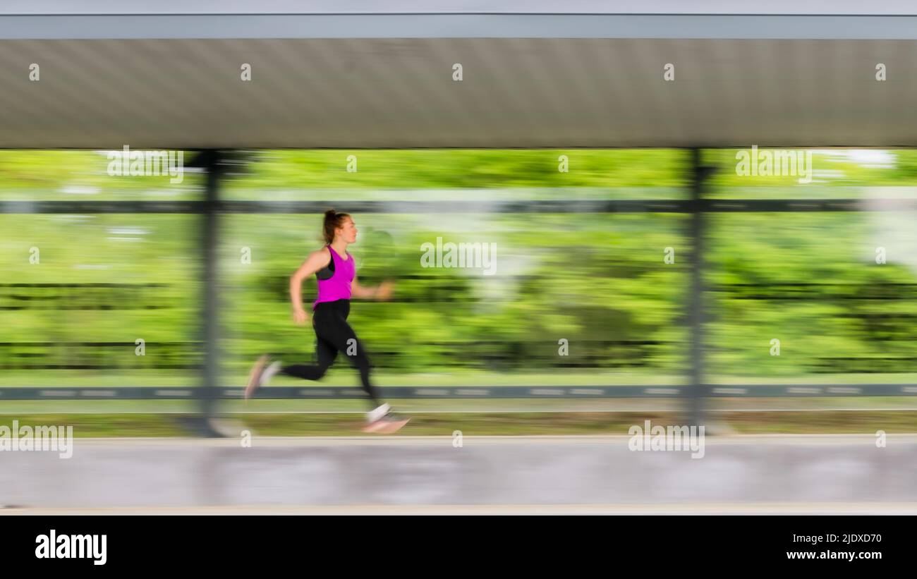Young athlete running in sports park Stock Photo - Alamy