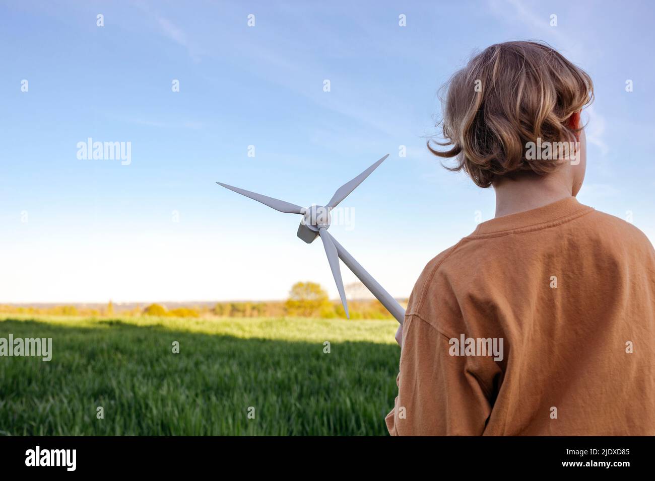 Boy with wind turbine model on field Stock Photo - Alamy