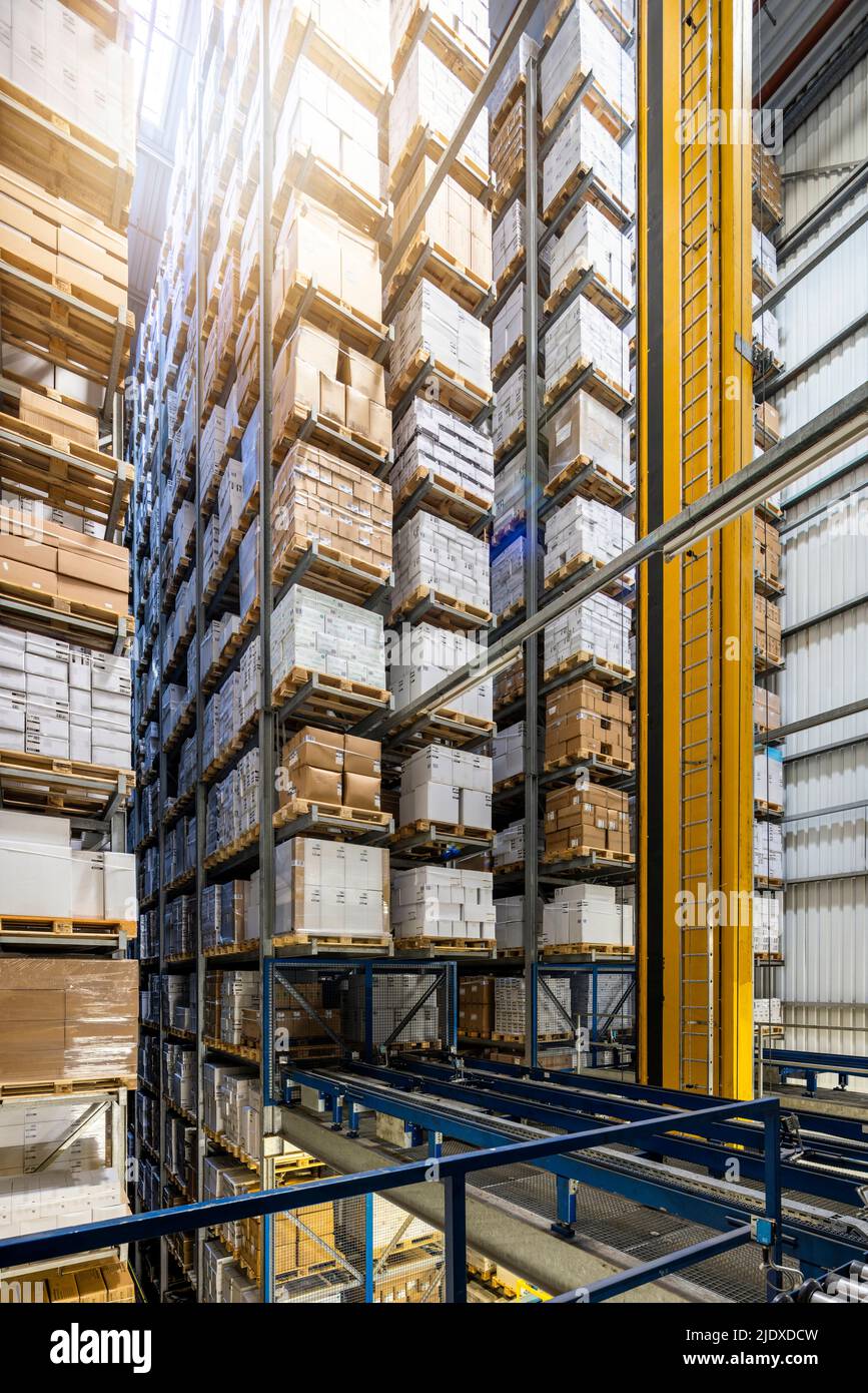 Cardboard boxes arranged on rack in distribution warehouse Stock Photo ...