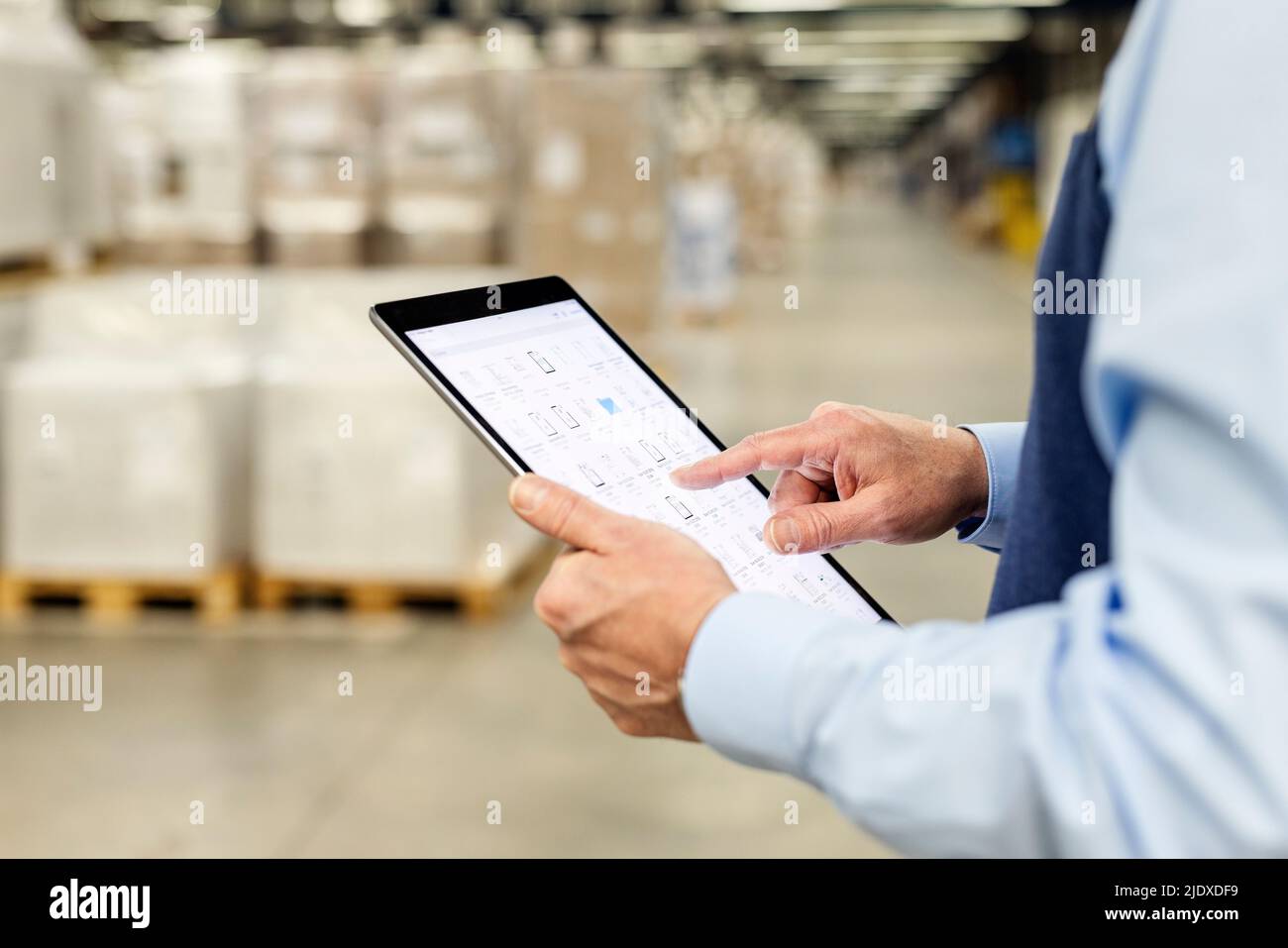 Hands of manager checking list through tablet PC in warehouse Stock ...