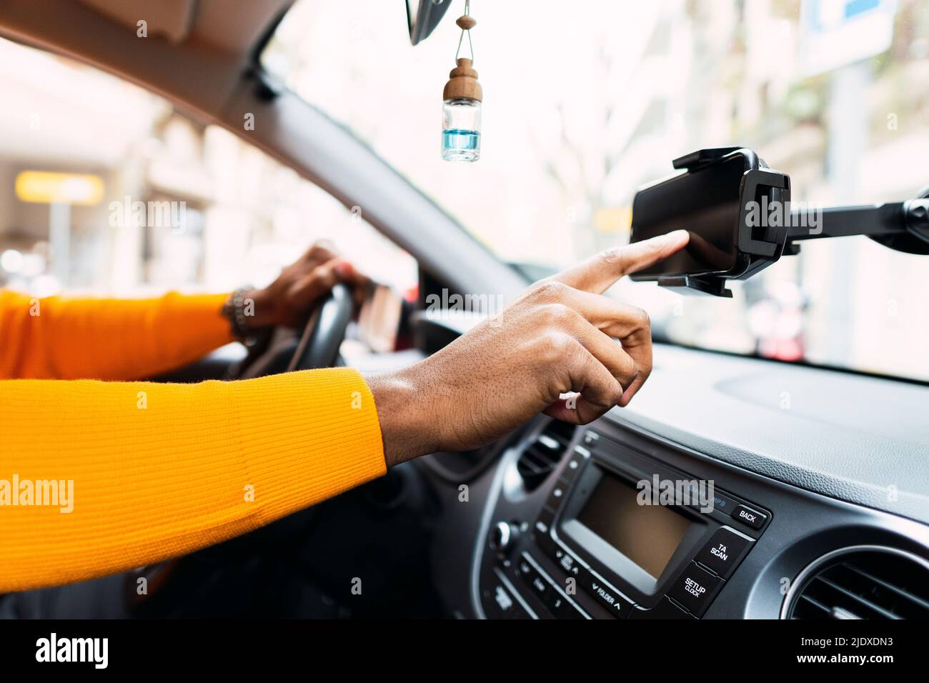 Hand of man touching smart phone screen in car Stock Photo - Alamy