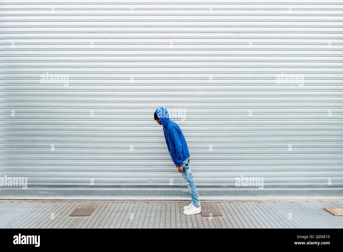 Man standing in front of roller shutter hi-res stock photography and ...