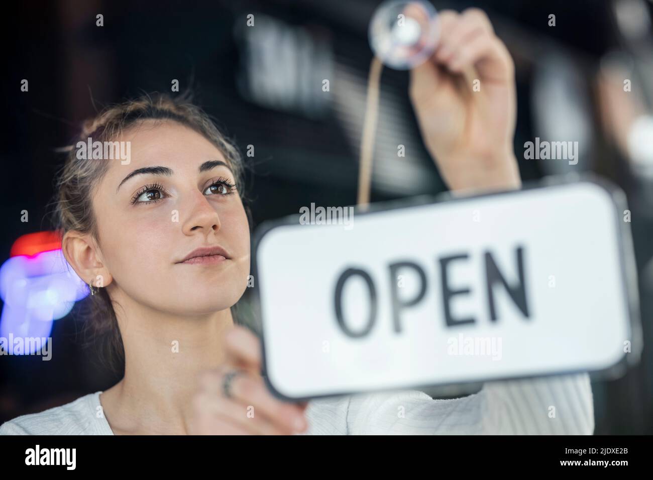 Restaurant owner hanging open sign board at glass door Stock Photo - Alamy