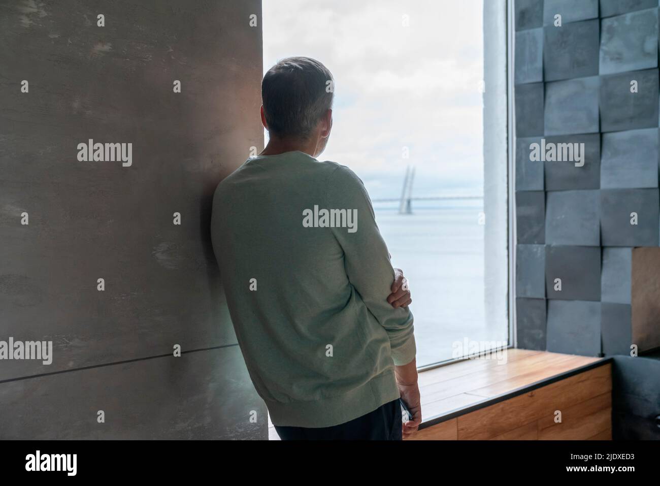 Man looking window home hi-res stock photography and images - Alamy