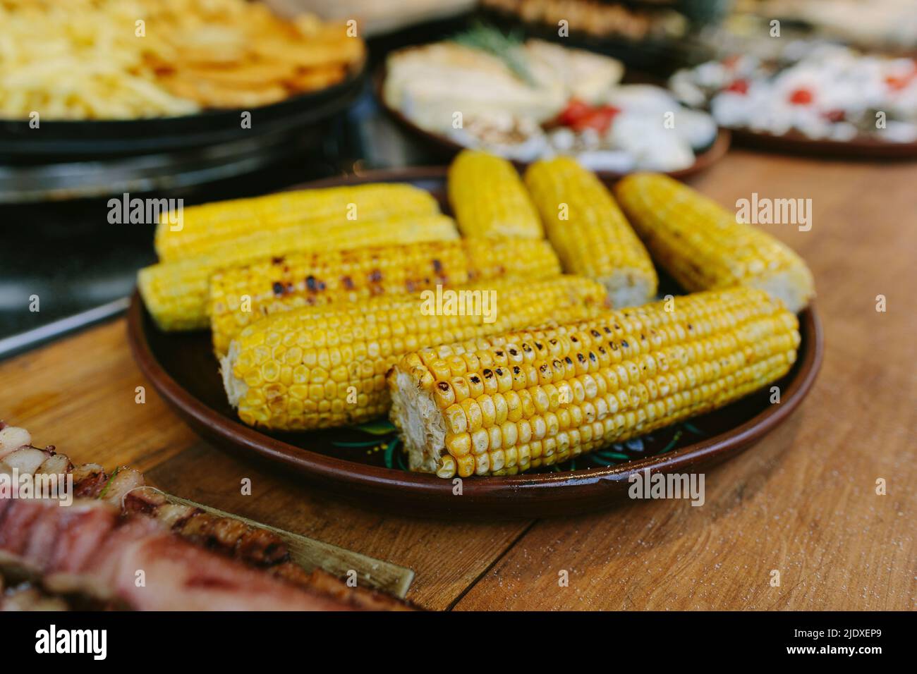 Roasted corn cobs on plate in restaurant Stock Photo - Alamy