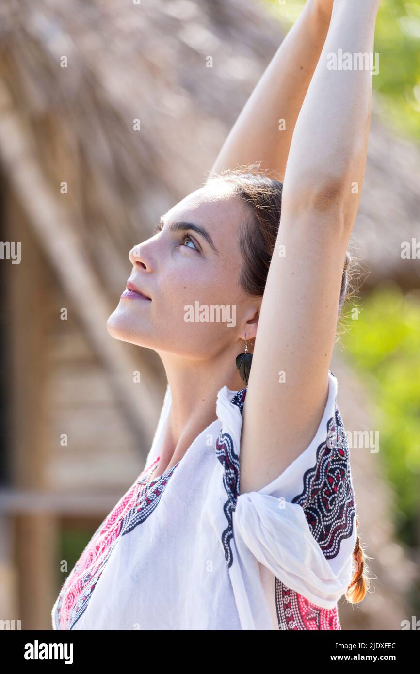 Woman raising arms side view hi-res stock photography and images - Alamy