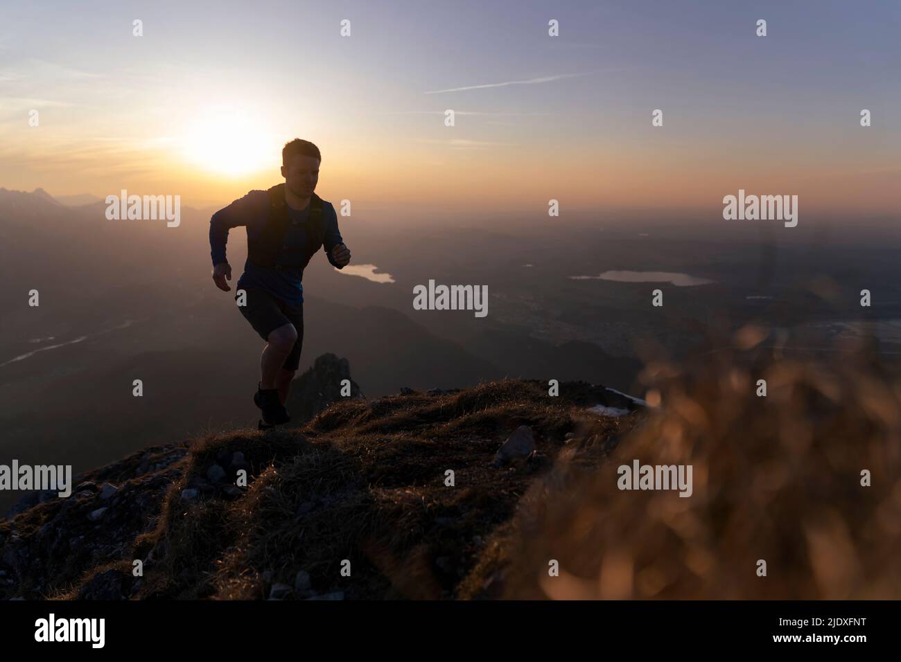 Silhouette hiker running on mountain at sunset Stock Photo - Alamy