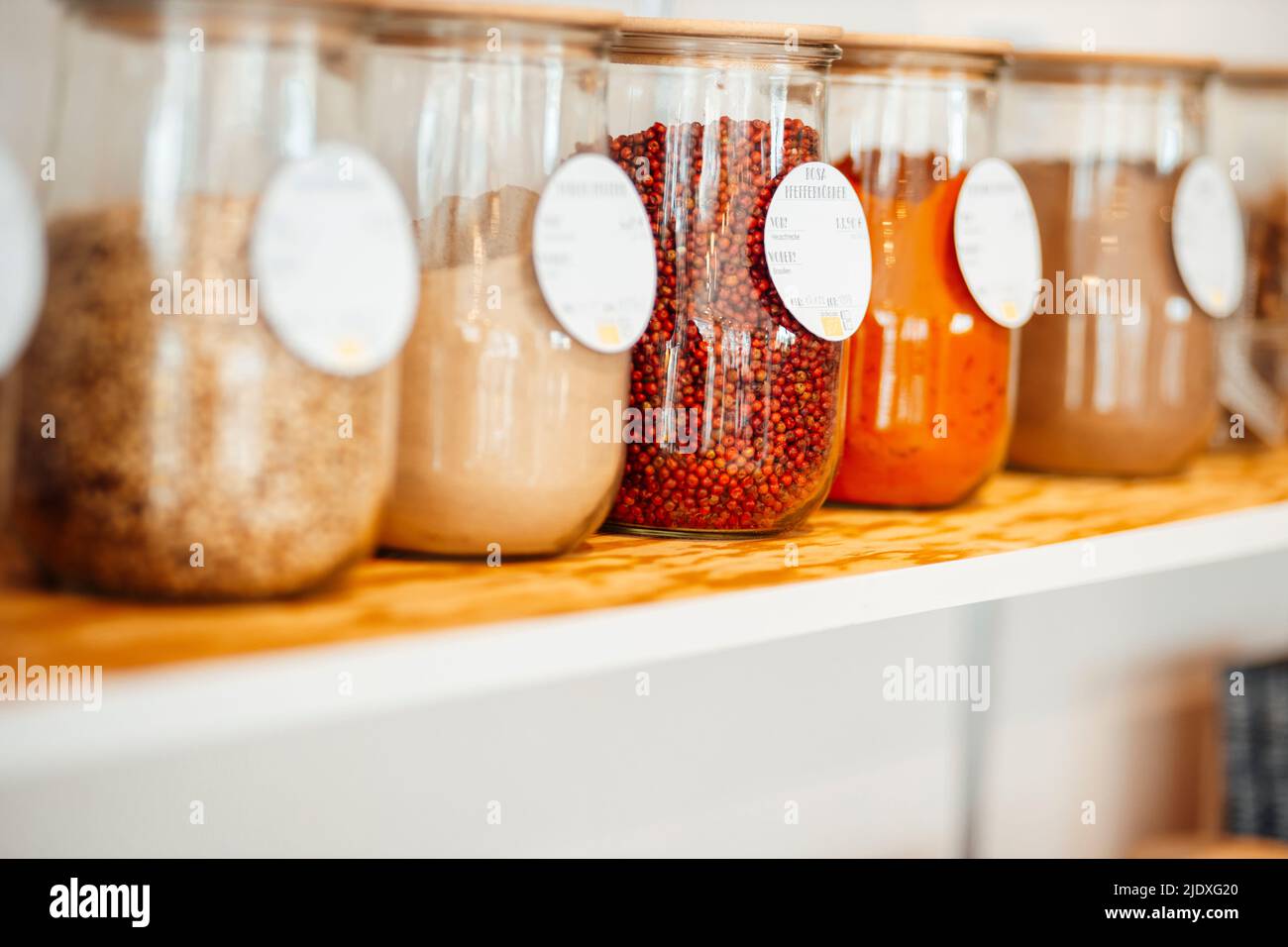 Ingredient jars with labels on shelf at cafe Stock Photo - Alamy