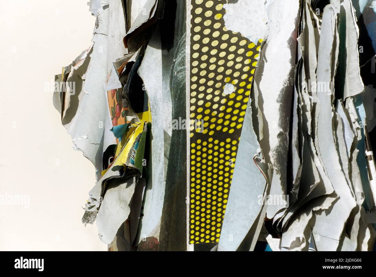 Torn advertisements hanging on advertising column Stock Photo - Alamy
