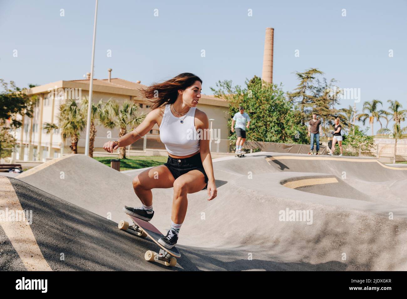 Young woman skateboarding on sports ramp at skatepark Stock Photo - Alamy