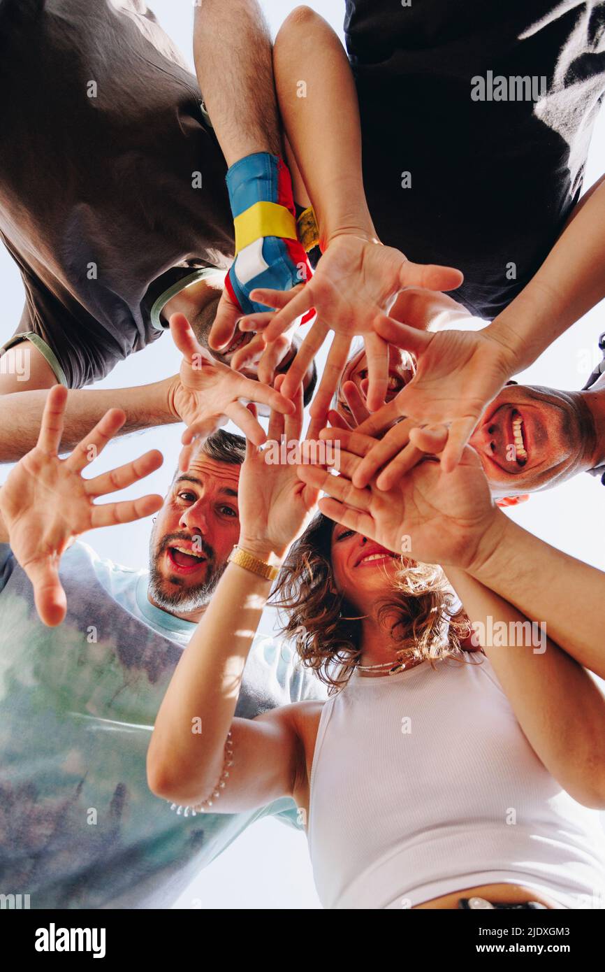 Playful men and women gesturing together Stock Photo - Alamy