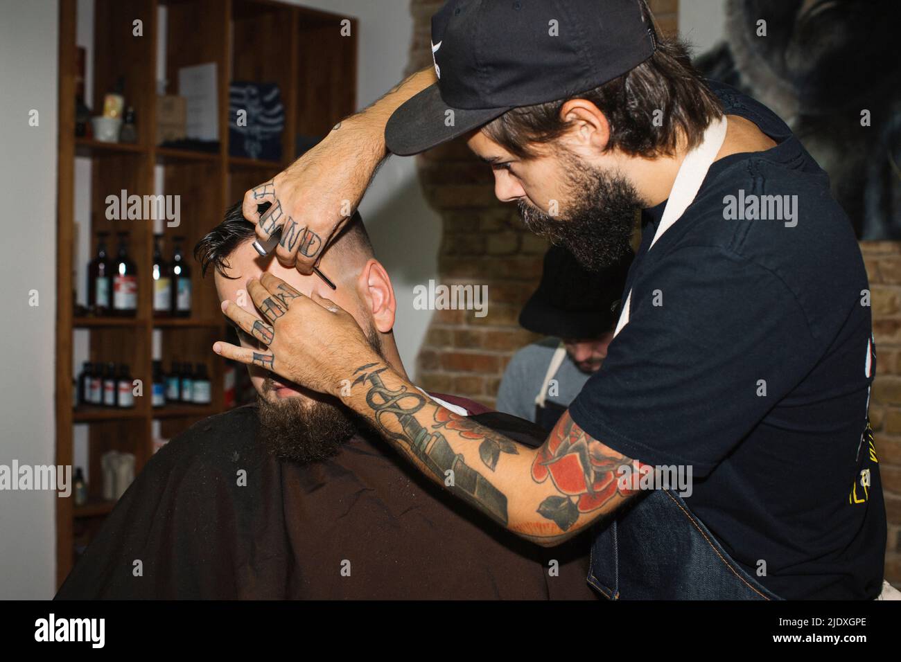 Man in barber shop getting his beard shaved with razor blade Stock ...