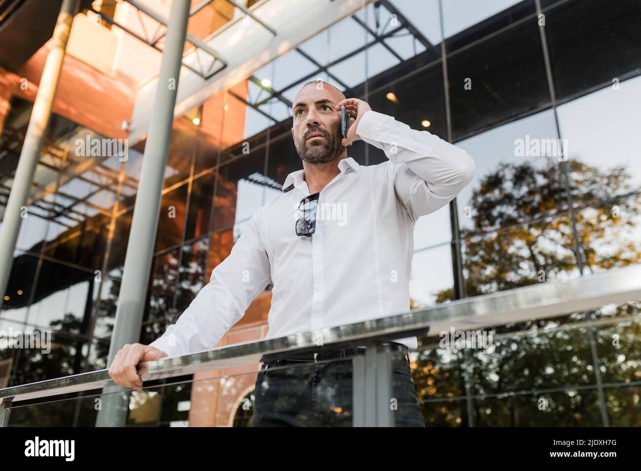 Serious man talking on phone hi-res stock photography and images - Alamy