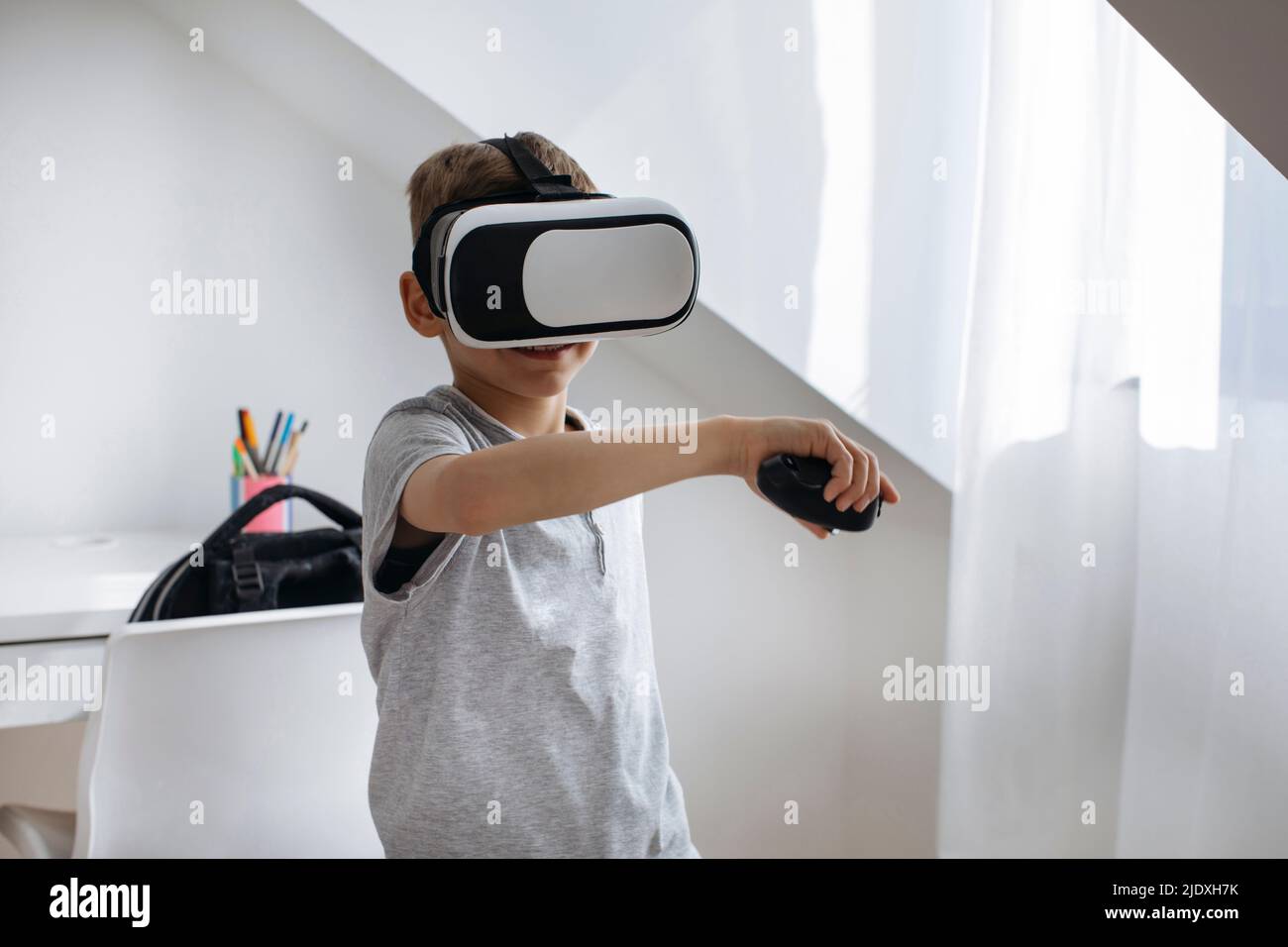 Boy with VR glasses playing video game at home Stock Photo - Alamy