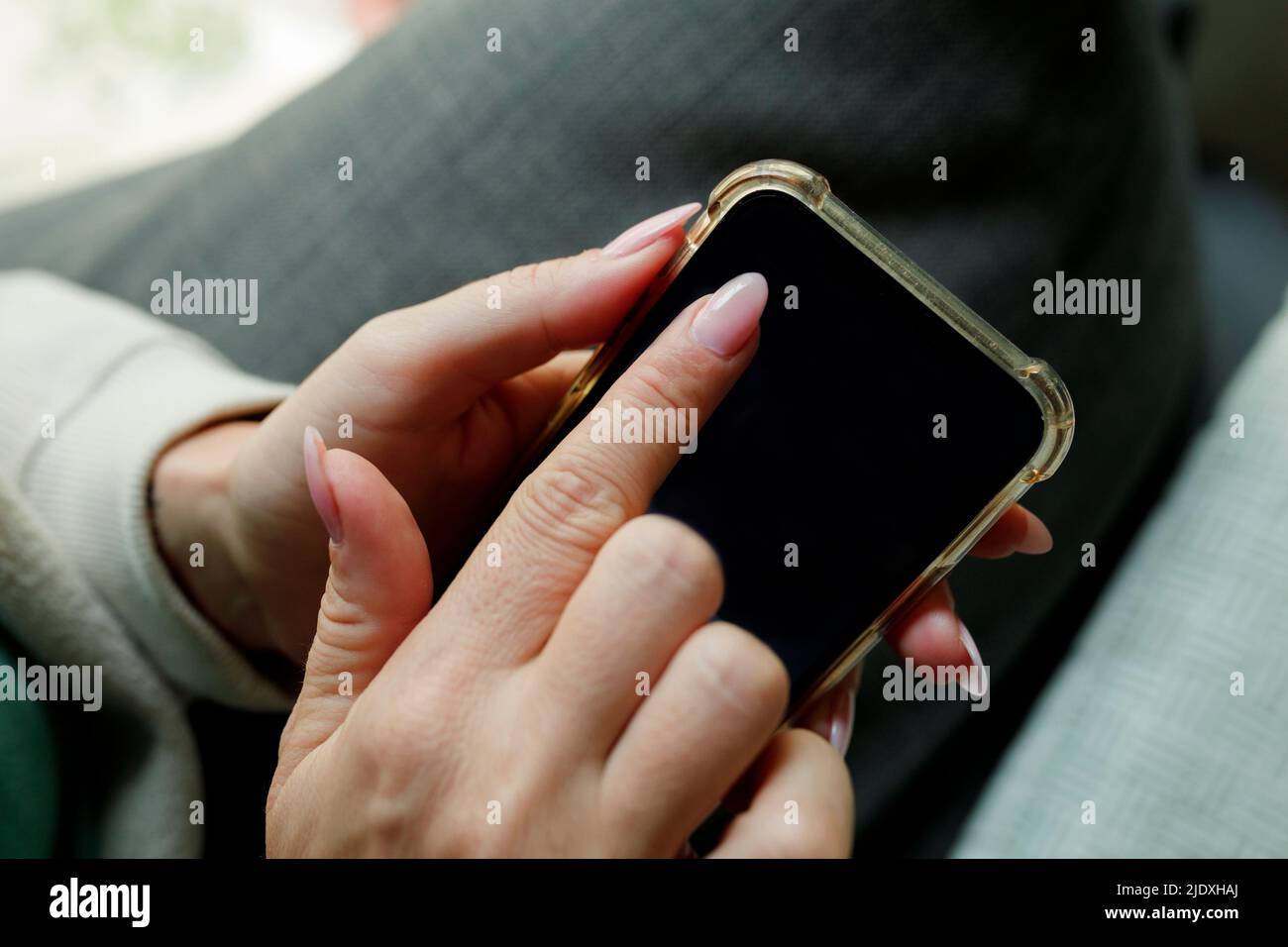 Woman touching mobile phone screen Stock Photo - Alamy