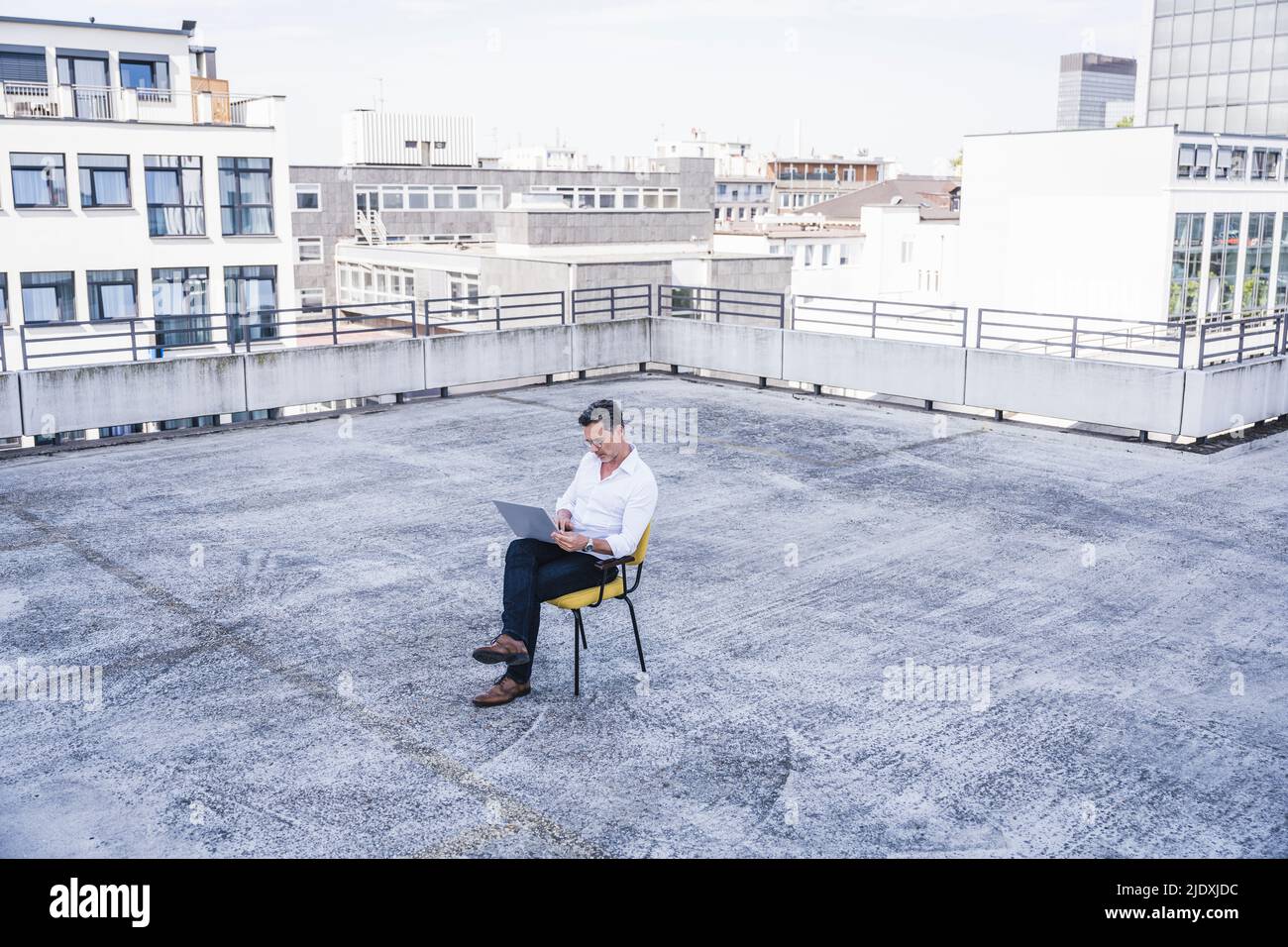 Businessman sitting deck chair laptop hi-res stock photography and ...