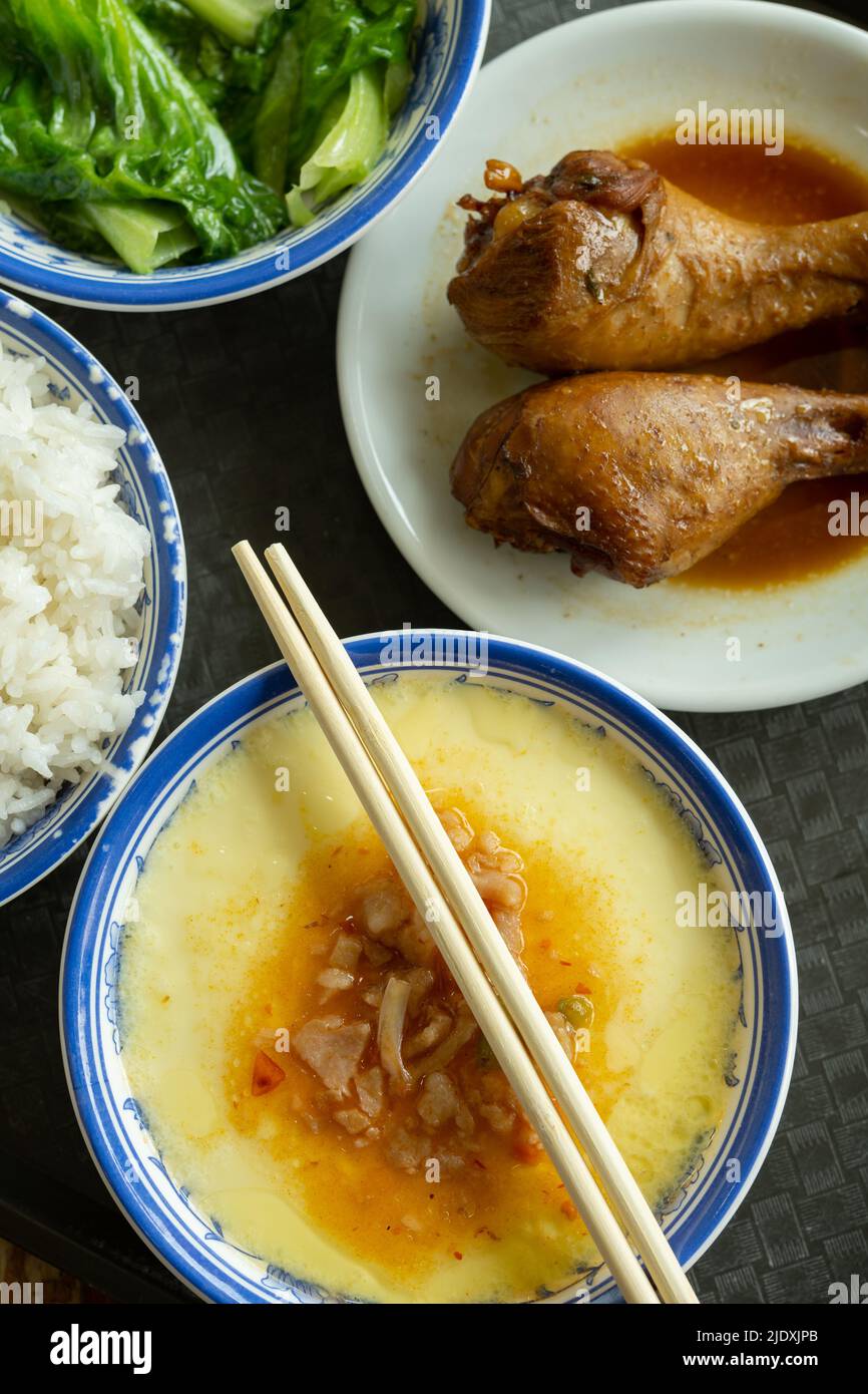 top view fast food of two chicken thighs and steamed eggs and vegetable ...
