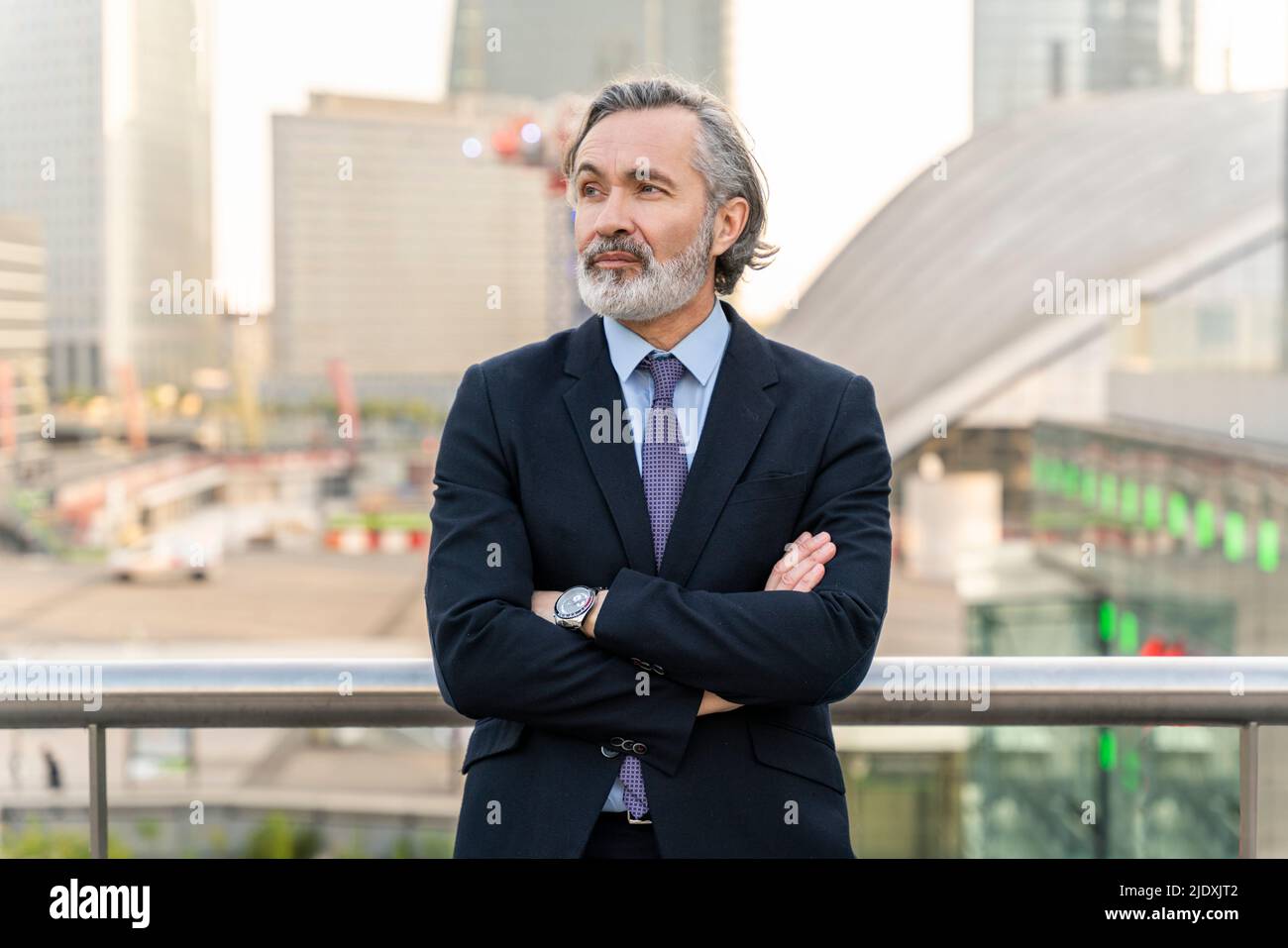 Businessman standing in front skyscraper hi-res stock photography and ...
