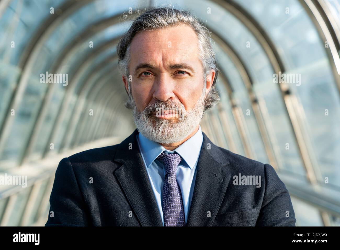 Businessman with gray hair on footbridge Stock Photo - Alamy