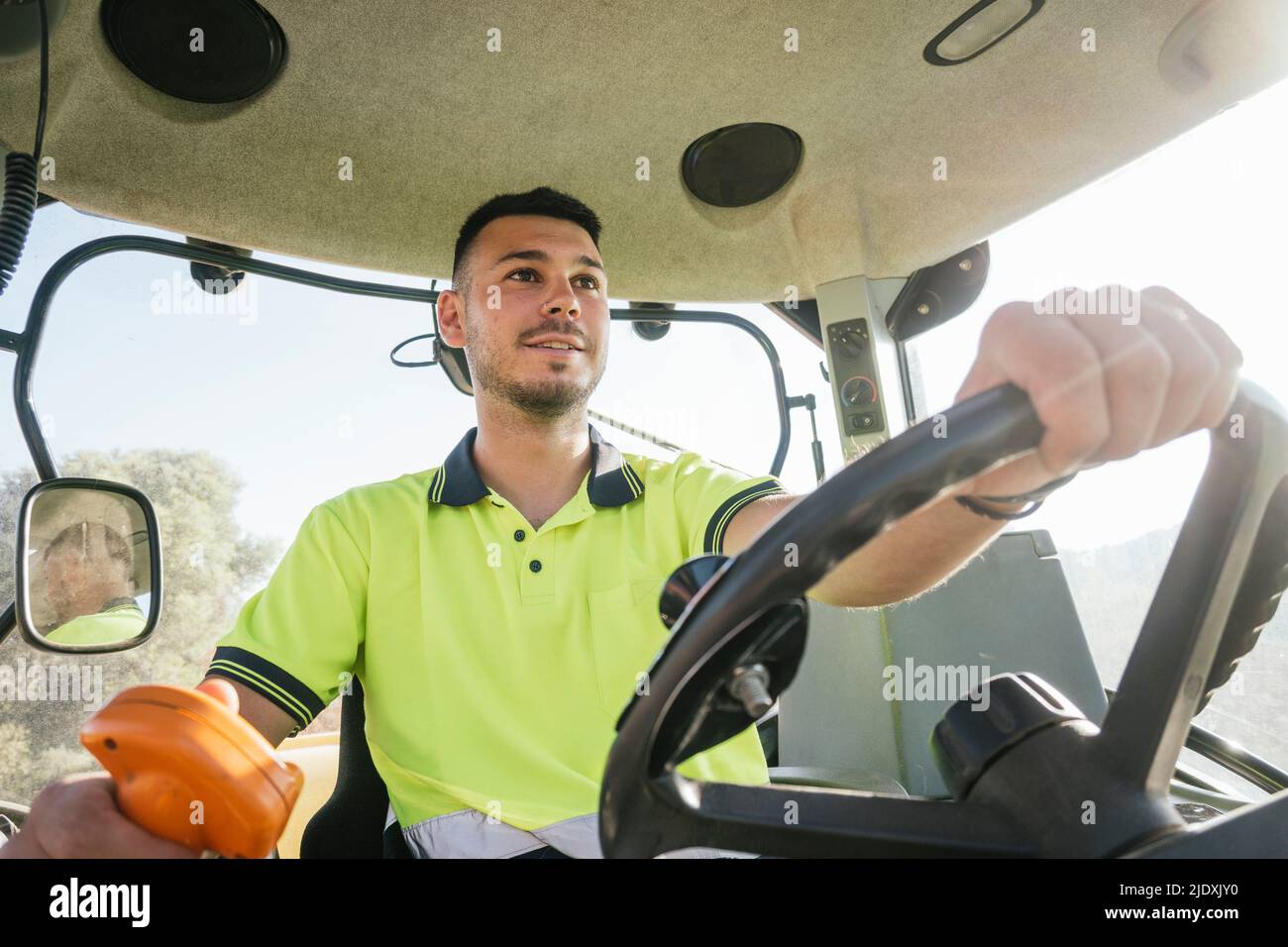 Young man sitting on tractor hi-res stock photography and images - Alamy