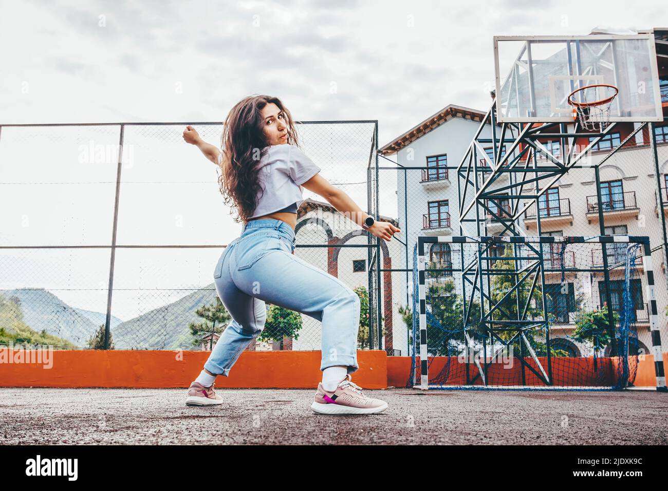 Woman dancing at basketball court Stock Photo - Alamy