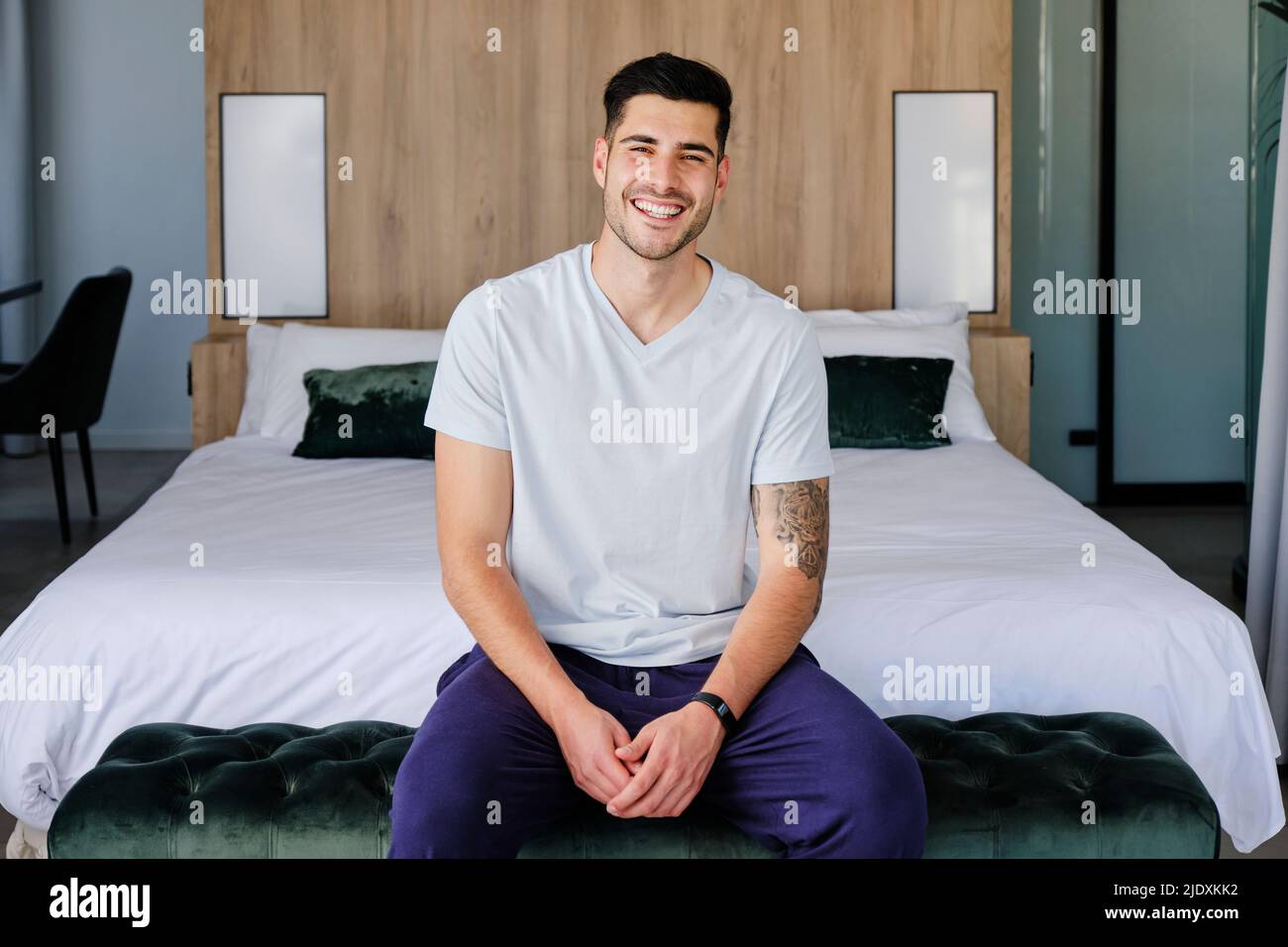 Young man in bedroom sitting hi-res stock photography and images - Alamy