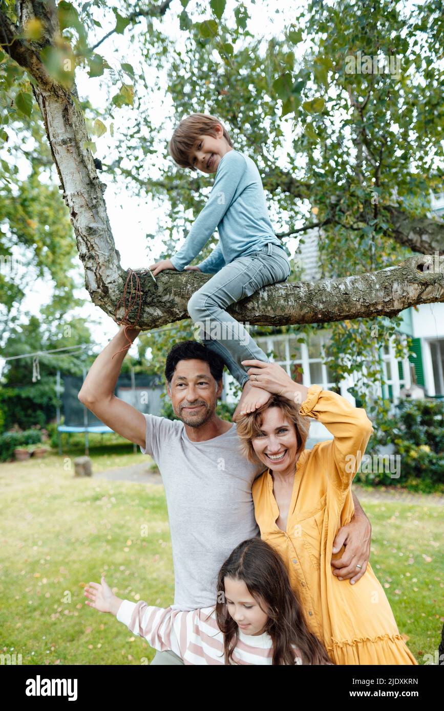 Happy family looking camera together hi-res stock photography and ...